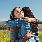 Friends, women and happy with hugging in countryside for travel ...