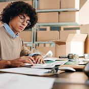 Man, writing and paperwork for distribution in warehouse, inventory ...