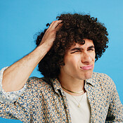 Confused, thinking and man with doubt in studio for decision, solution ...