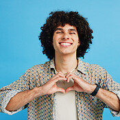 Studio, happy man and portrait with hands for heart, emoji shape and ...