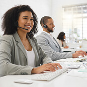 Young happy mixed race female call center agent answering calls while ...