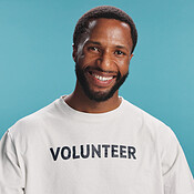 Happy, volunteer and portrait of man in studio with ngo community ...