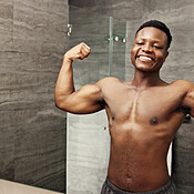Smile, black man and mirror for flexing in bathroom of fitness progress ...