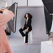 Production, woman and studio photographer with model for magazine ...