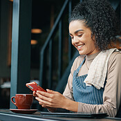 Woman, waiter and phone for typing at cafe, social media break and ...