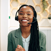Headset, portrait and smile of black woman concierge at front desk of hotel for hospitality or ...