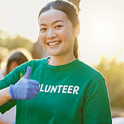 Portrait, volunteer and happy woman with thumbs up outdoor for ...