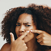Portrait, African woman and skincare for acne, checking and skin ...