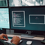 Person, military and typing on computer screen in control room, report battle and monitoring war ...