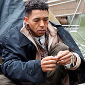 Man, poverty and homeless with drugs at park, package and thinking with ...