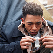 Man, poverty and homeless with drugs in bag at park, package and ...