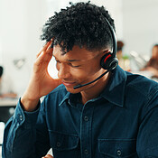 Headset, stress and support with man in call center for assistance ...