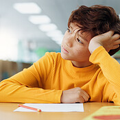 Thinking, kid and student in library at school for planning, ideas and ...