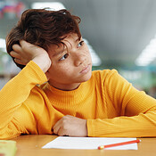 Thinking, boy and student in library at school for planning, ideas and ...