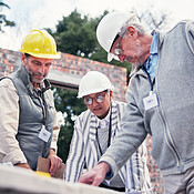 Construction site, people and discussion for floor plan, blueprint and ...