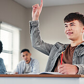 Question, hands up and student in classroom with answer for lesson ...