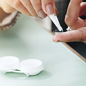 Optometry, contact lens and closeup of person with container for eye ...