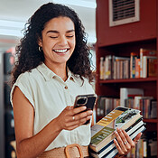 Woman, phone and books with texting at library with smile, contact and ...