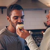 Men, gay couple and feeding food in home for nutrition, health and ...