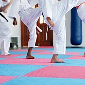Karate, children and legs at dojo for fighting, self defense or fitness ...