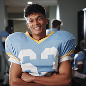 Man, football player or portrait in locker room with arms crossed, gear ...