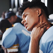 Man, American football player and neck pain with stress in locker room ...