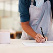 Workshop, hands and inspection with paperwork for pottery, small ...