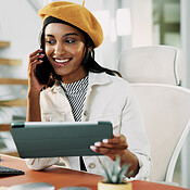 Happy, woman and phone call with tablet in office for discussion ...