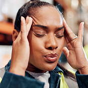 Woman, face and headache with burnout at warehouse, shipping stress or ...