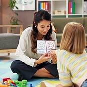 Woman, teacher and child in classroom with visual lesson for private ...