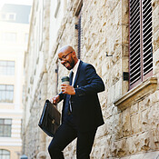 Dancing, lawyer and black man in city, smile and promotion with success ...