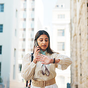 Business woman, phone call and watch in city for taxi, driver or stress ...