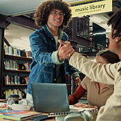 Group, handshake and college with friends in library for STEM education ...
