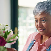 Senior woman, bouquet and flowers at house for special occasion ...