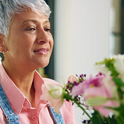 Senior woman, flowers and gift at house for special occasion, aesthetic ...