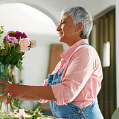Senior woman, flowers and vase at house for special occasion, aesthetic ...