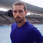 Runner, portrait and health with man on race track for athlete ...