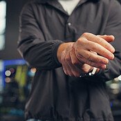 Hands, wrist pain and man in gym, exercise and fibromyalgia with muscle ...
