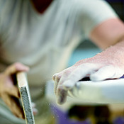 Hands, person and sanding foam in workshop for surfing equipment ...