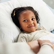 Medical, smile and patient or child in hospital bed for icu recovery ...