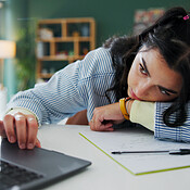 College student, girl and tired with laptop in home for exam revision ...