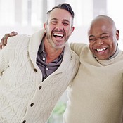 Three diverse men standing together in unity while smiling, laughing ...