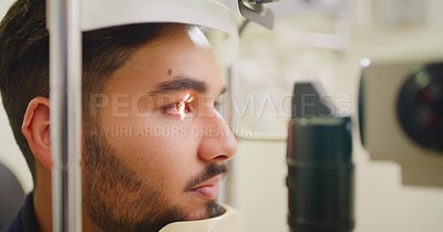 Closeup of a slit lamp machine testing eye and pupil reflexes of a male ...