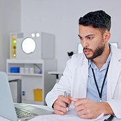 Frustrated, angry and stressed scientist hitting his laptop in anger ...