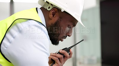 Busy engineer talking on a walkie talkie radio communication on site ...