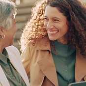 Tablet, travel and social media with a woman and mother in the city for ...