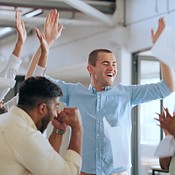 Business people throw paper, applause and hug while celebrating achievement, goals or victory ...