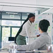 Corporate training, black woman and leader with staff, planning and ...