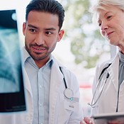 X ray, consulting and teamwork of doctors in hospital with tablet ...