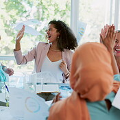 Applause, winner or high five with a business team throwing documents during collaboration at a ...